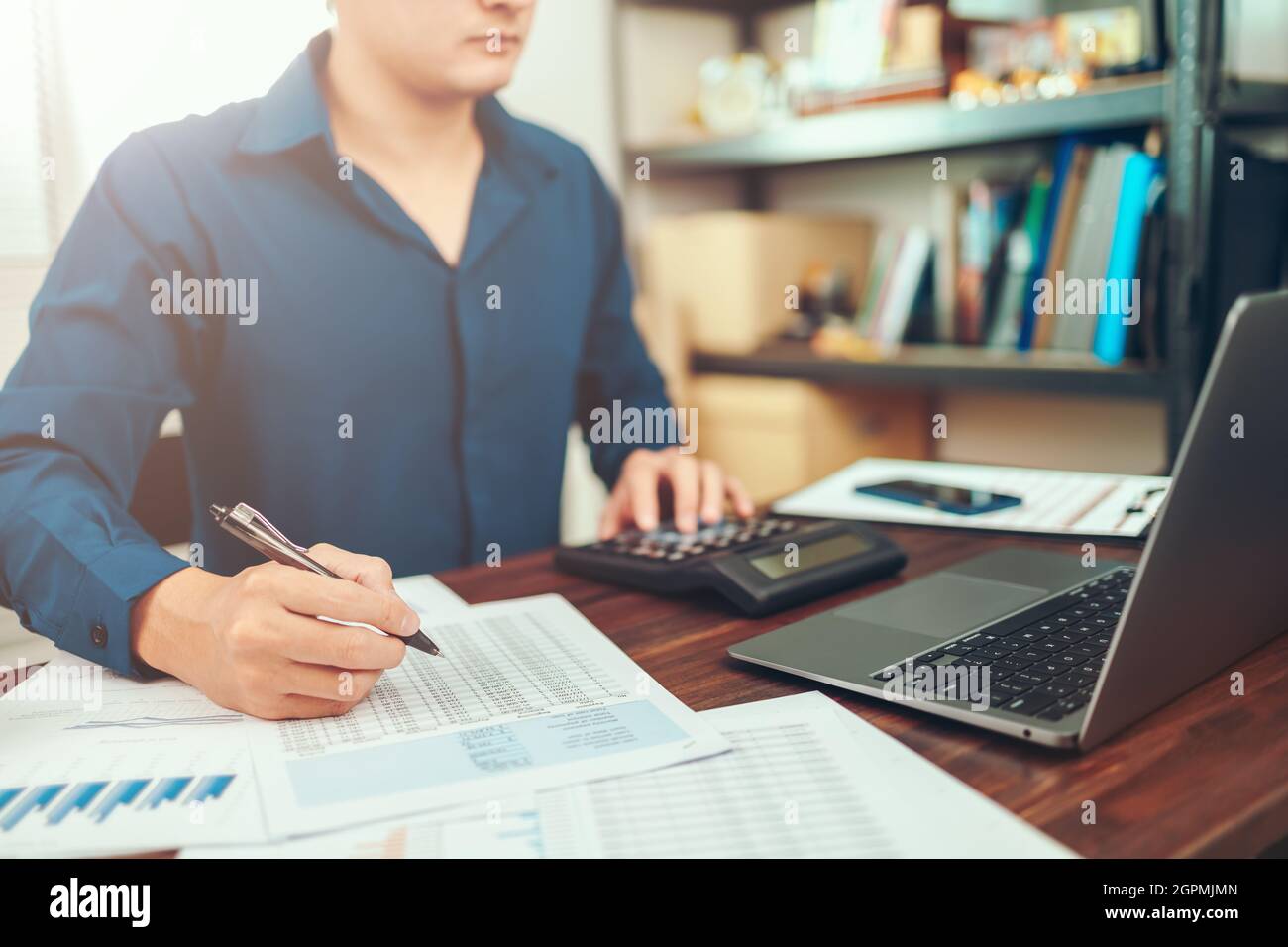 Accounting woking with data sheet on the office desk. Calculator with ...