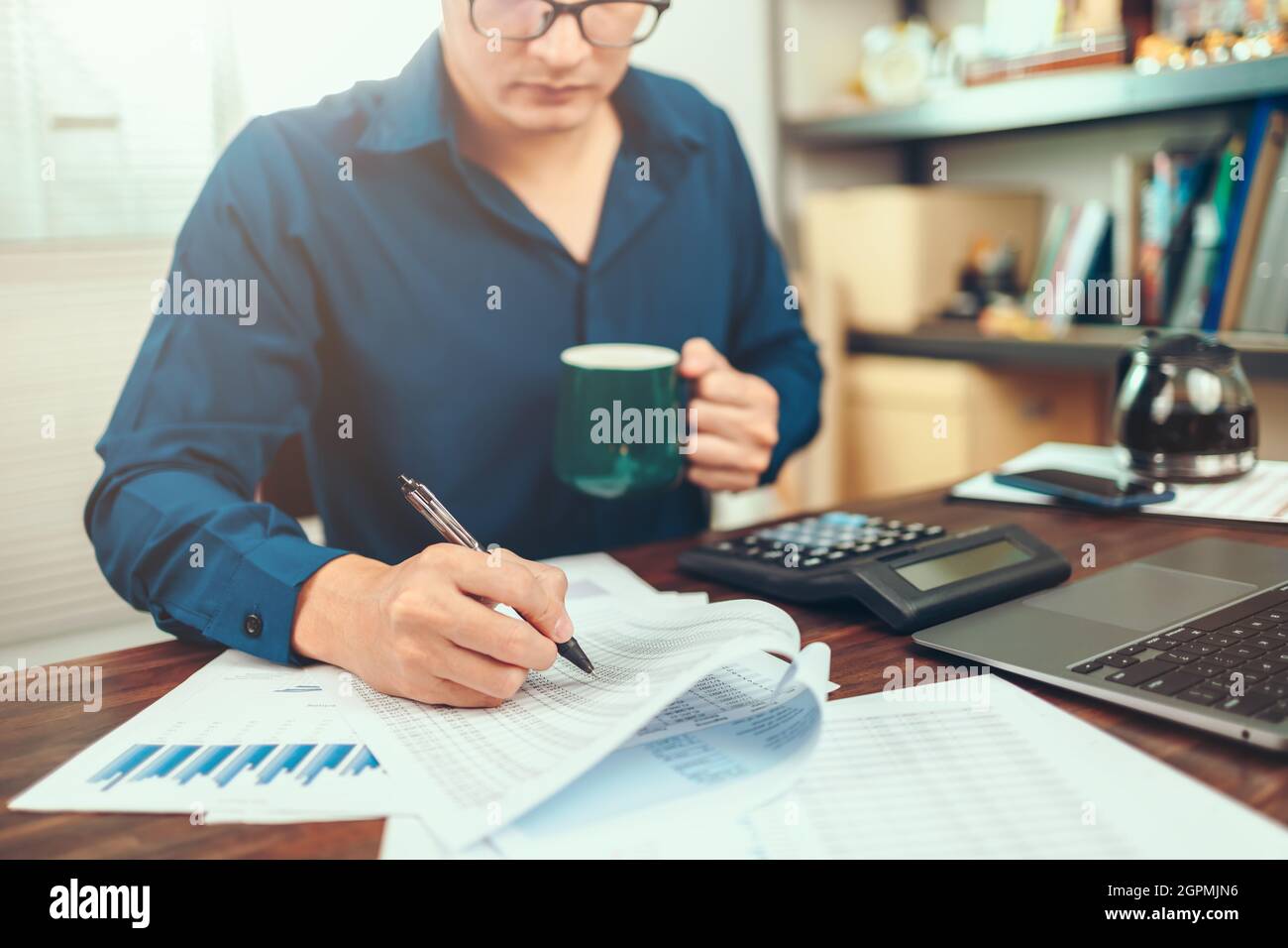 Accounting woking with data sheet on the office desk. Calculator with ...