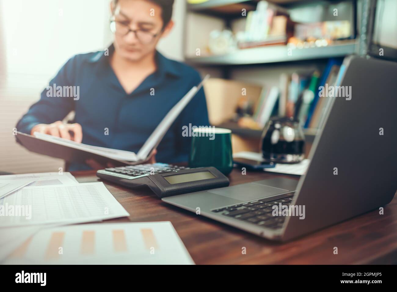 Calculator with accounting report and financial statement on desk ...