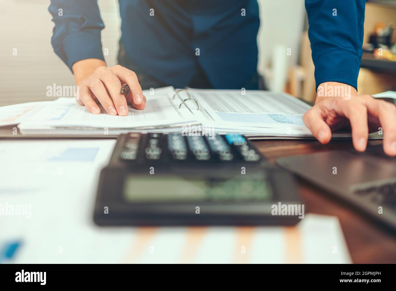 Accounting woking with data sheet on the office desk. Calculator with ...