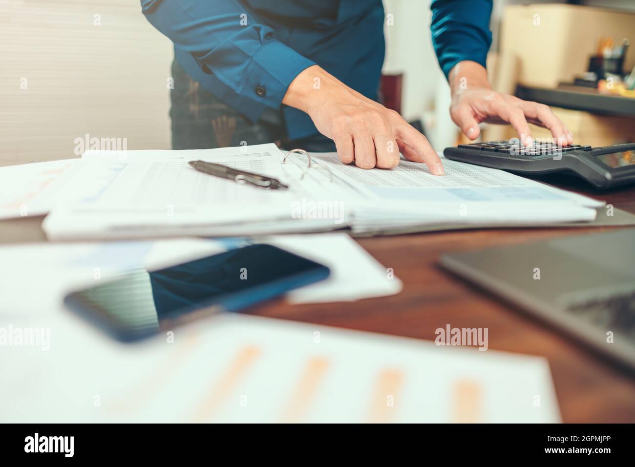 Accounting woking with data sheet on the office desk. Calculator with ...