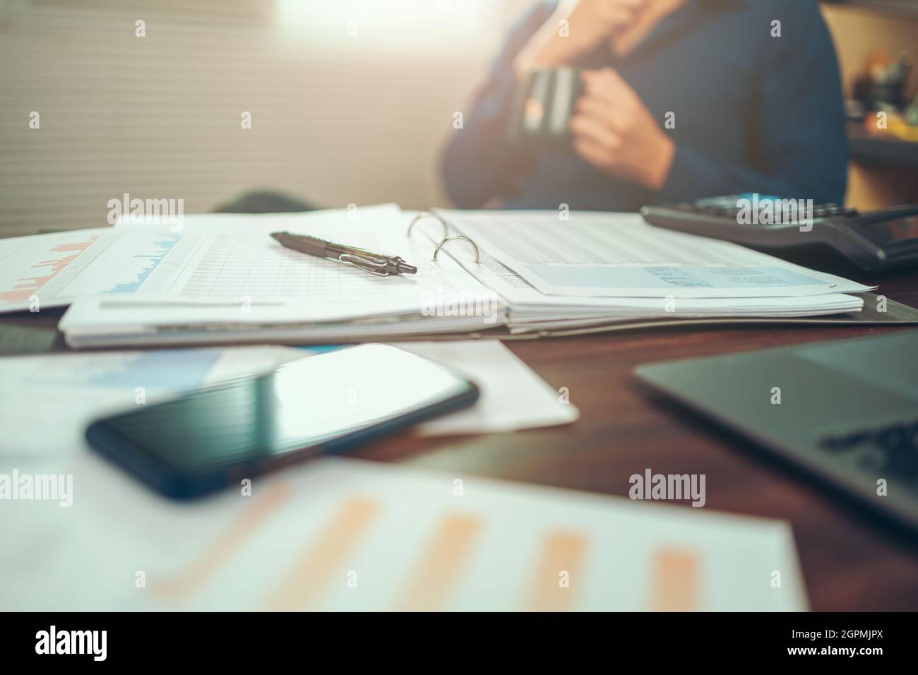 Accounting woking with data sheet on the office desk. Calculator with ...