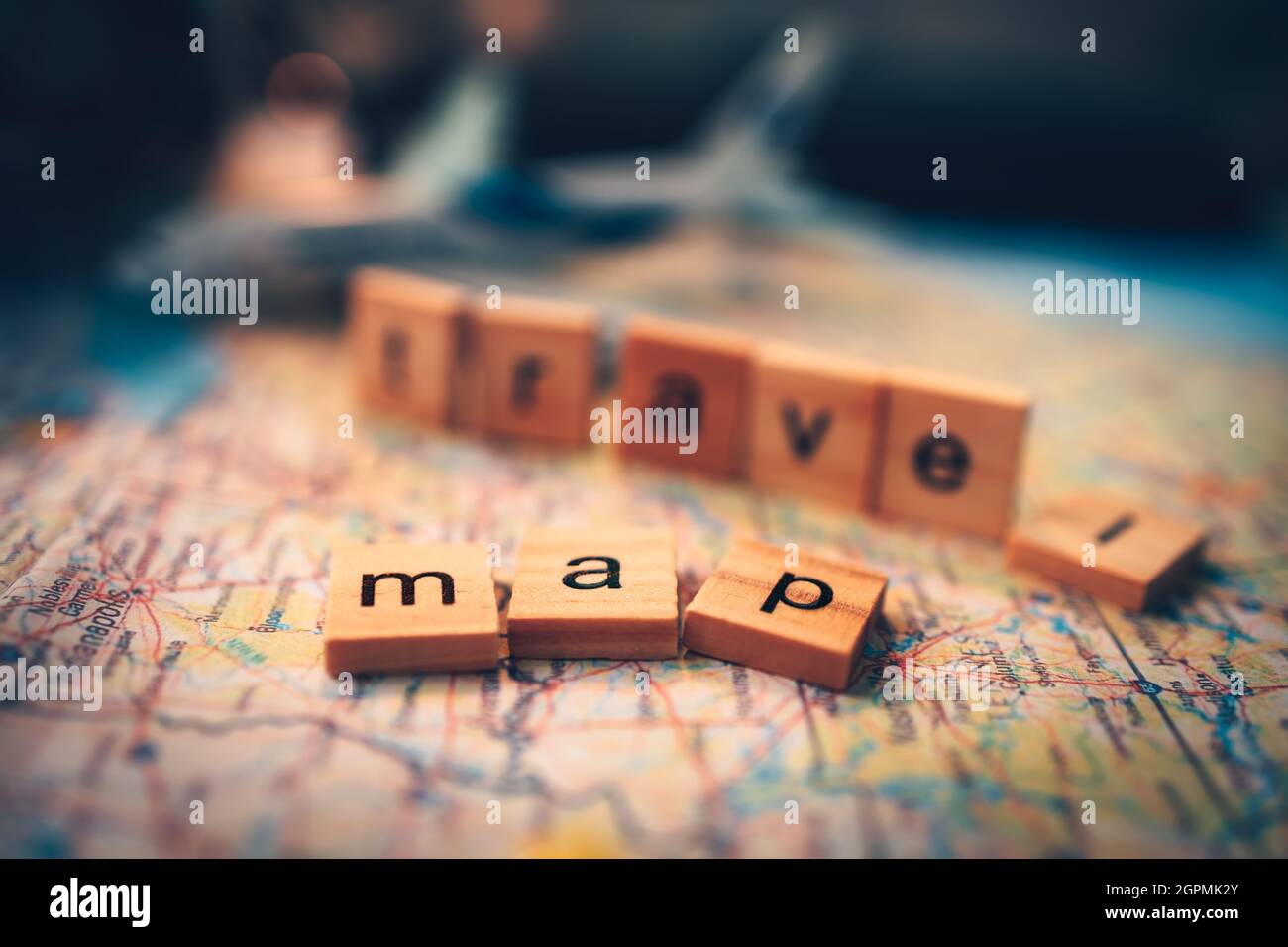 Wood square with word "map" and "travel" on the map. Travel plan ...