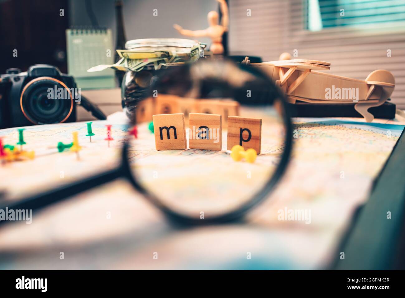 Magnifying glass with Wood square with word "map" on the map. pushpin ...