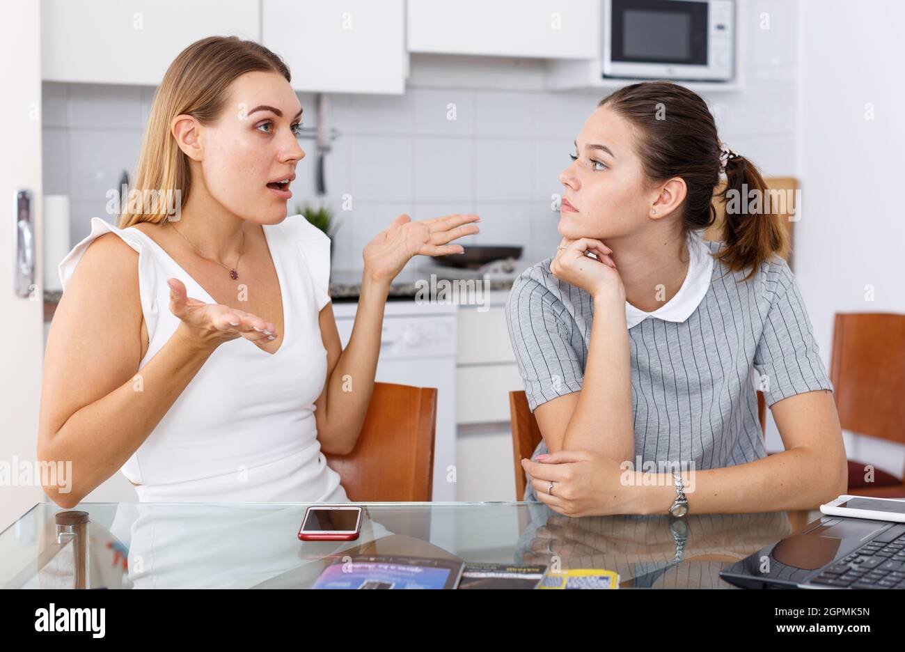 Two girls having emotional conversation Stock Photo - Alamy