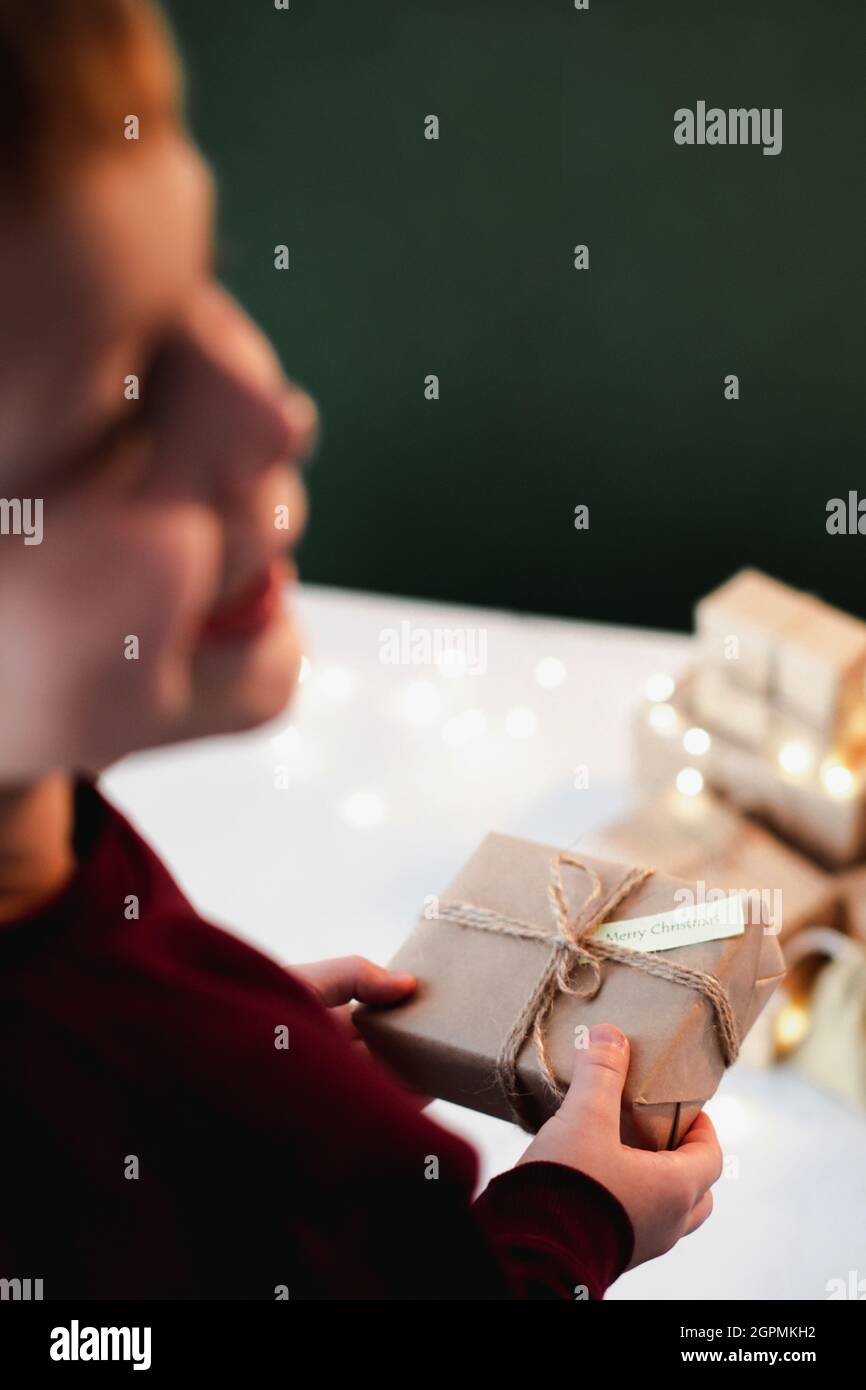 Children's hands holding Christmas gift box, ecological Christmas ...