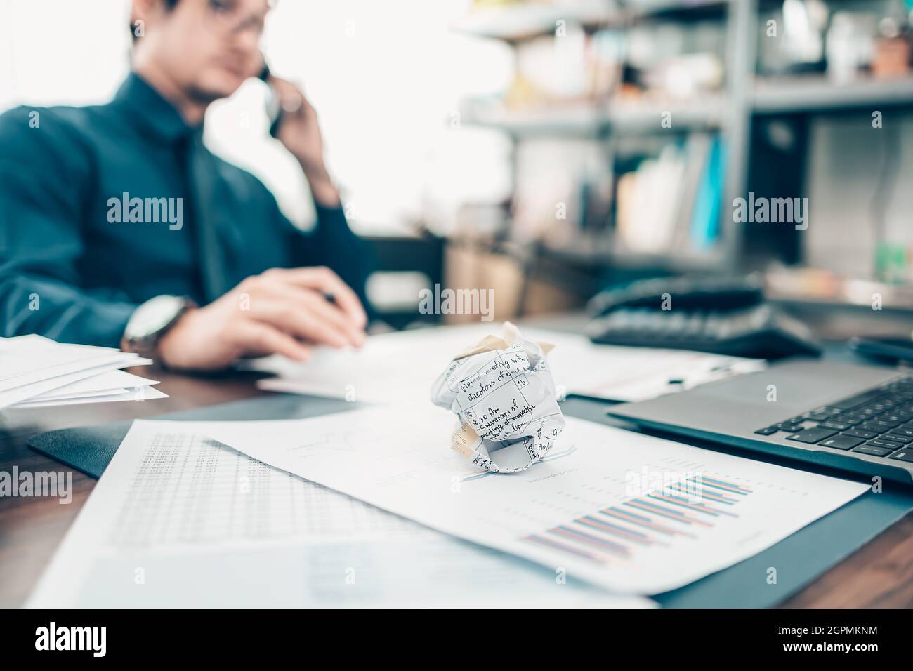 Crumpled papers on office desk. Business strain feeling was frustrated ...