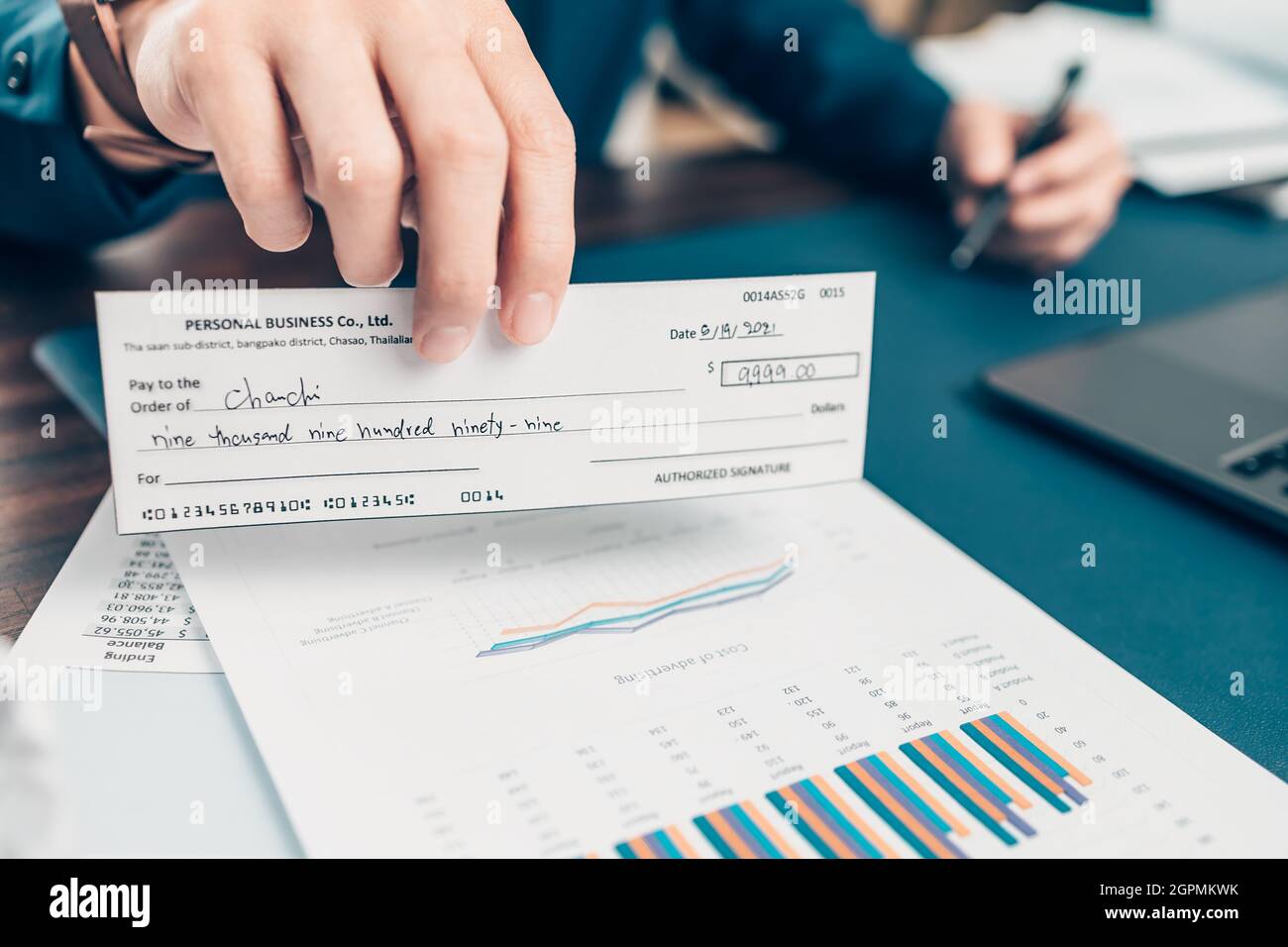 A Businessperson's hand giving cheque to customer and dollar bill, coin ...