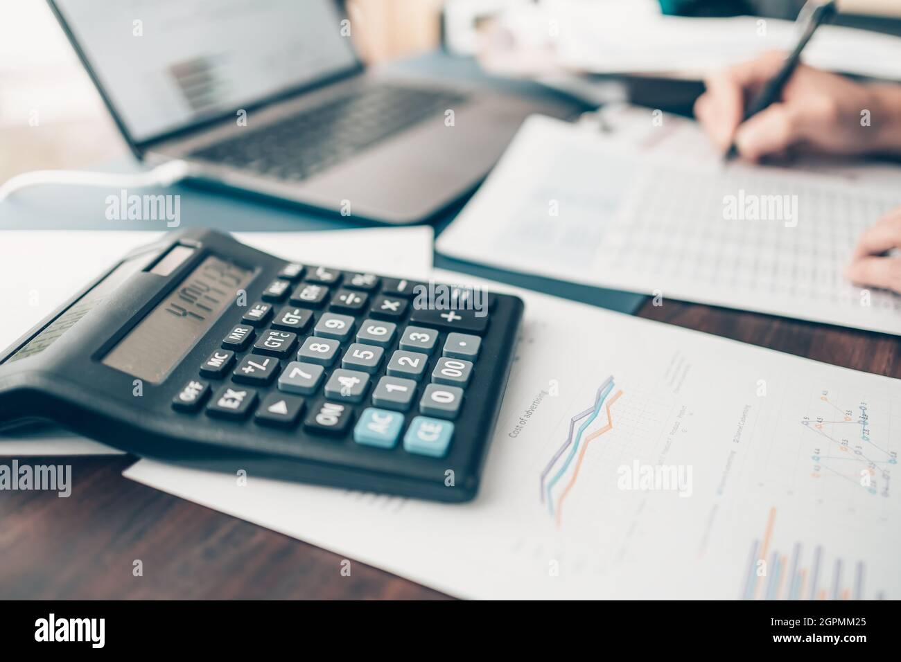Financial businessman working on desk office using a calculator to ...