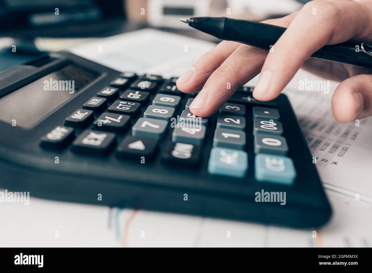 Financial businessman working on desk office using a calculator to ...