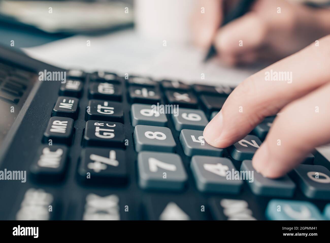 Financial businessman working on desk office using a calculator to ...