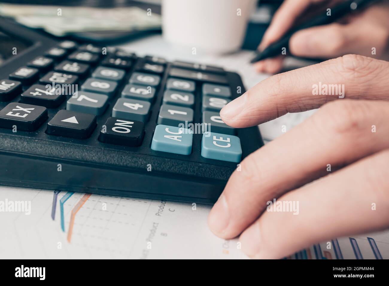 Financial businessman working on desk office using a calculator to ...