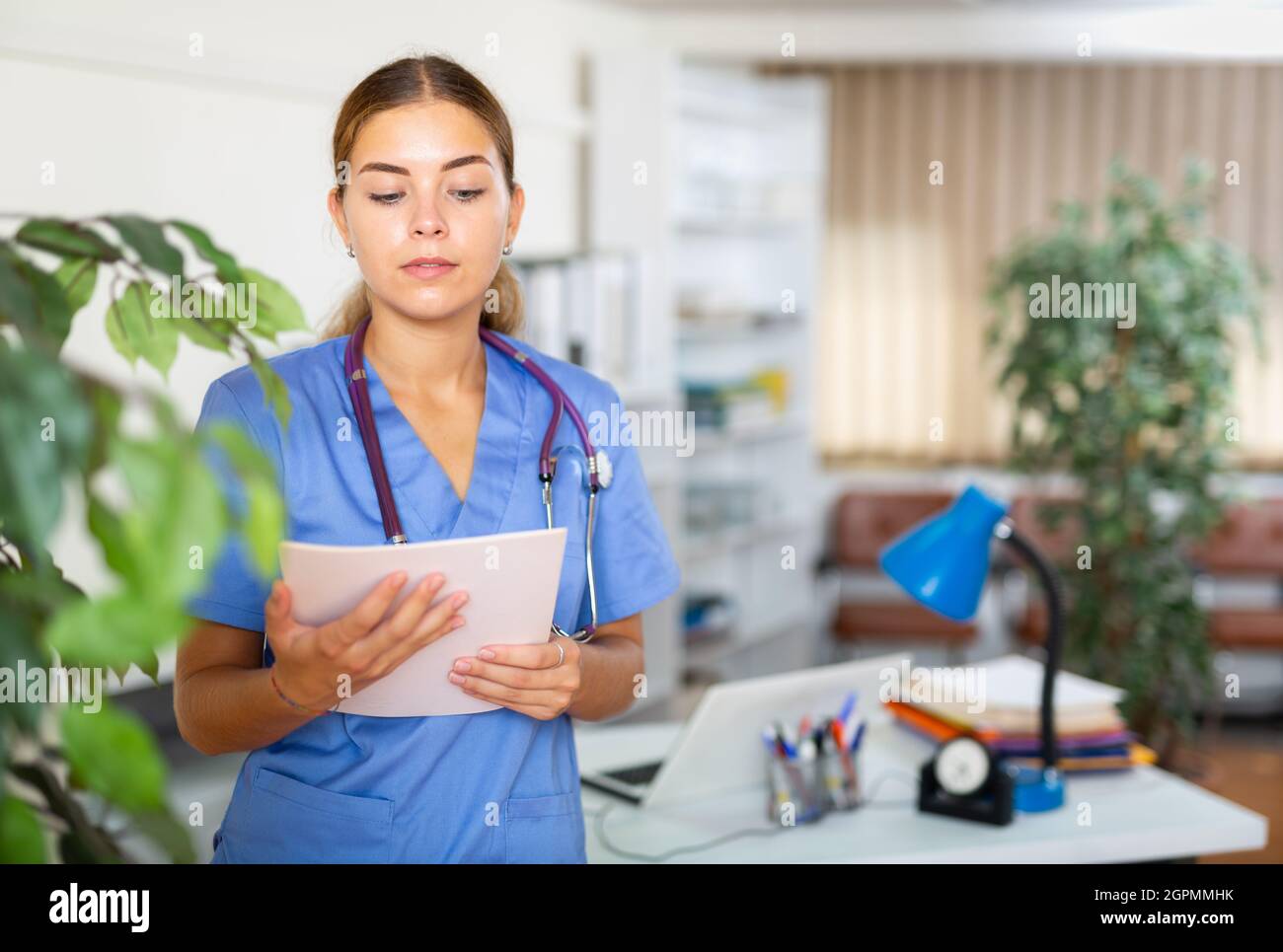 Female doctor reviewing medical history of patient in office Stock ...