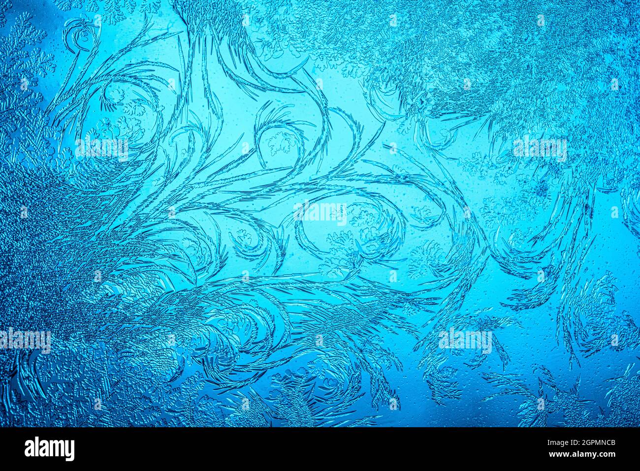 Beautiful blue frost patterns on frozen window as a symbol of Christmas ...