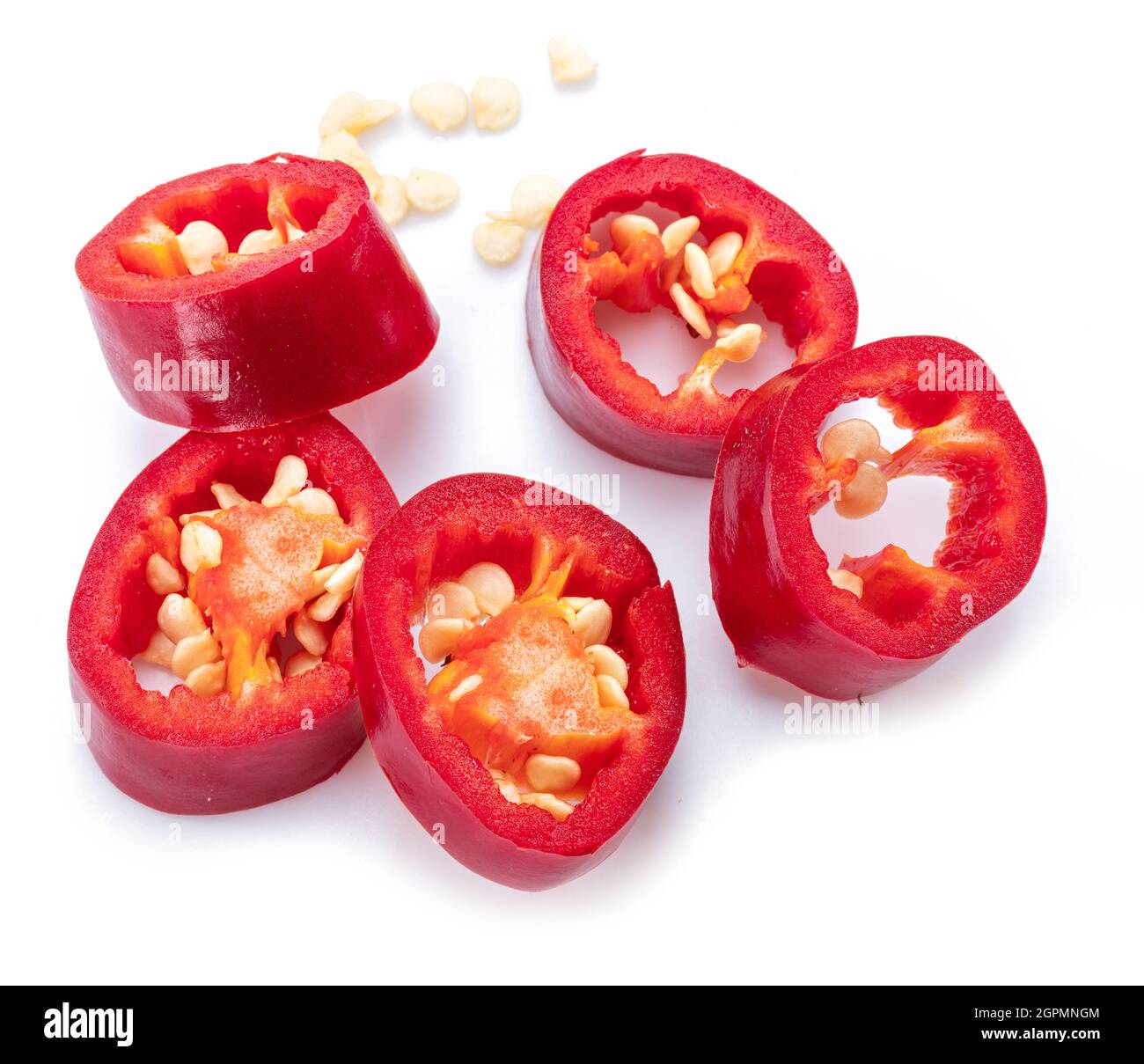 Cross sections of fresh chilli pepper with seeds isolated on white ...