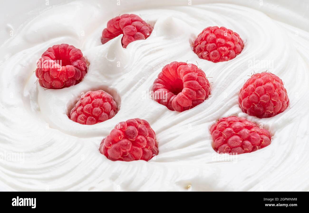 Fresh raspberries in the yoghurt or cream. Top view Stock Photo - Alamy