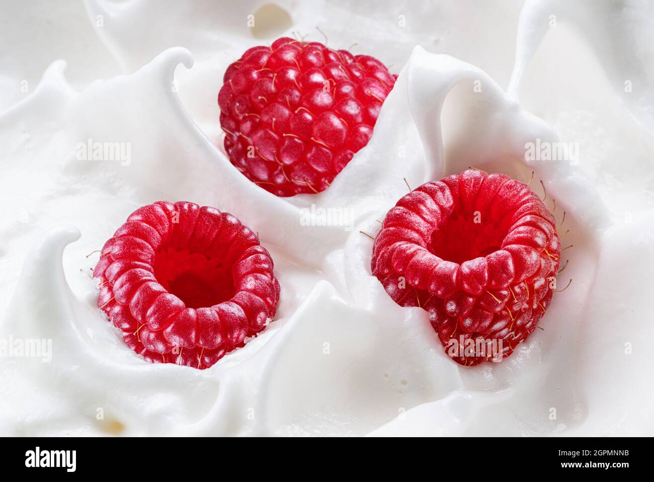 Fresh raspberries in the yoghurt or cream. Top view Stock Photo - Alamy
