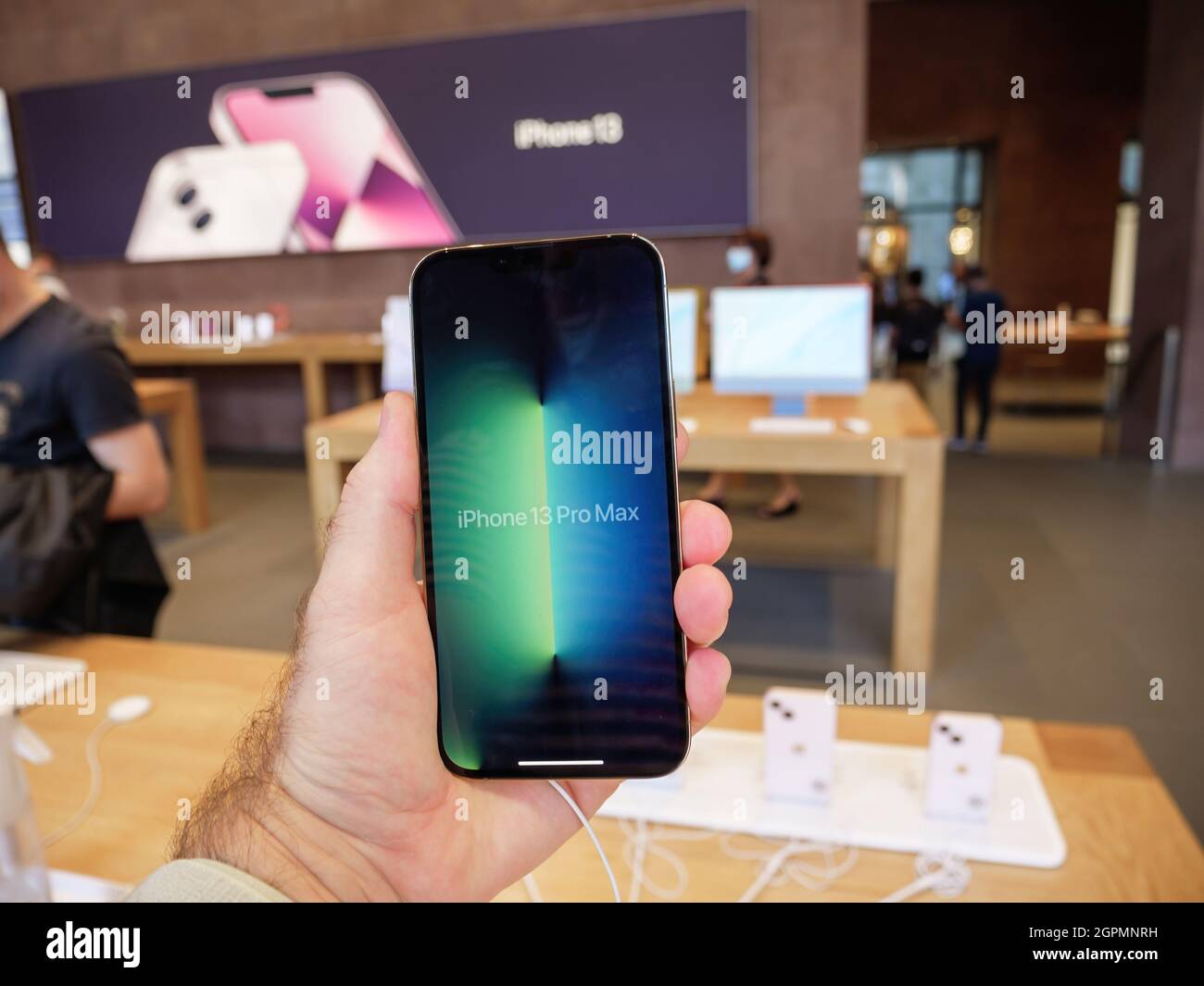 Male hand looking at retina display with ProMotion 120 hz on iPhone 13 ...