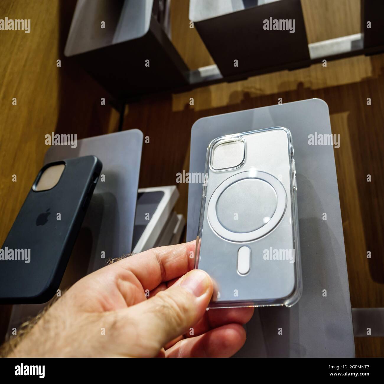 Man hand testing transparent protection cases of iPhone 13 Pro with ...