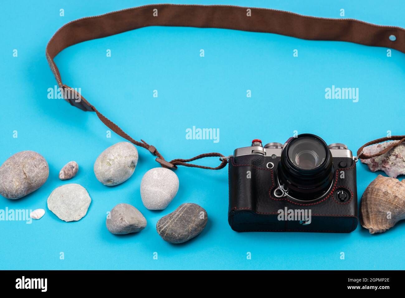 camera and seashells on a blue background.Background for the traveler ...