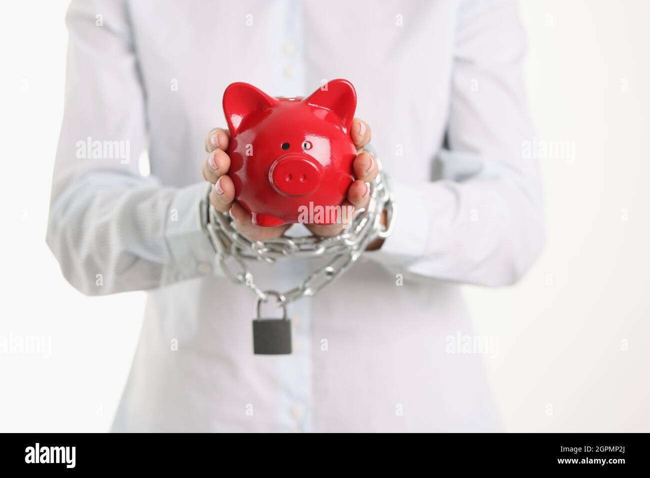 Female tied hands with chain hold red pig piggy bank closeup Stock ...