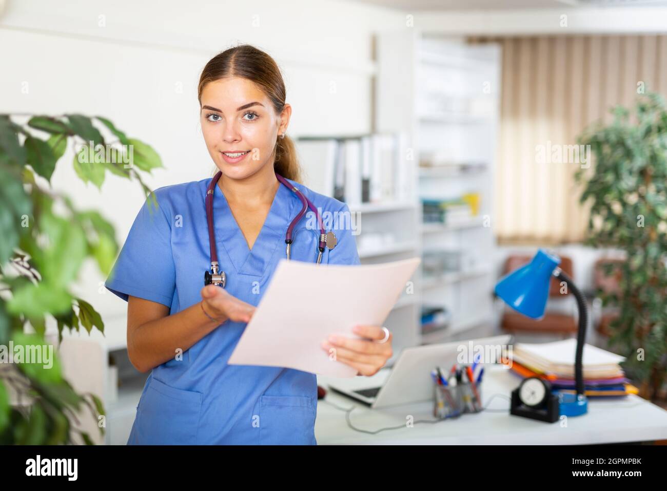 Female doctor standing in hall of clinic Stock Photo - Alamy