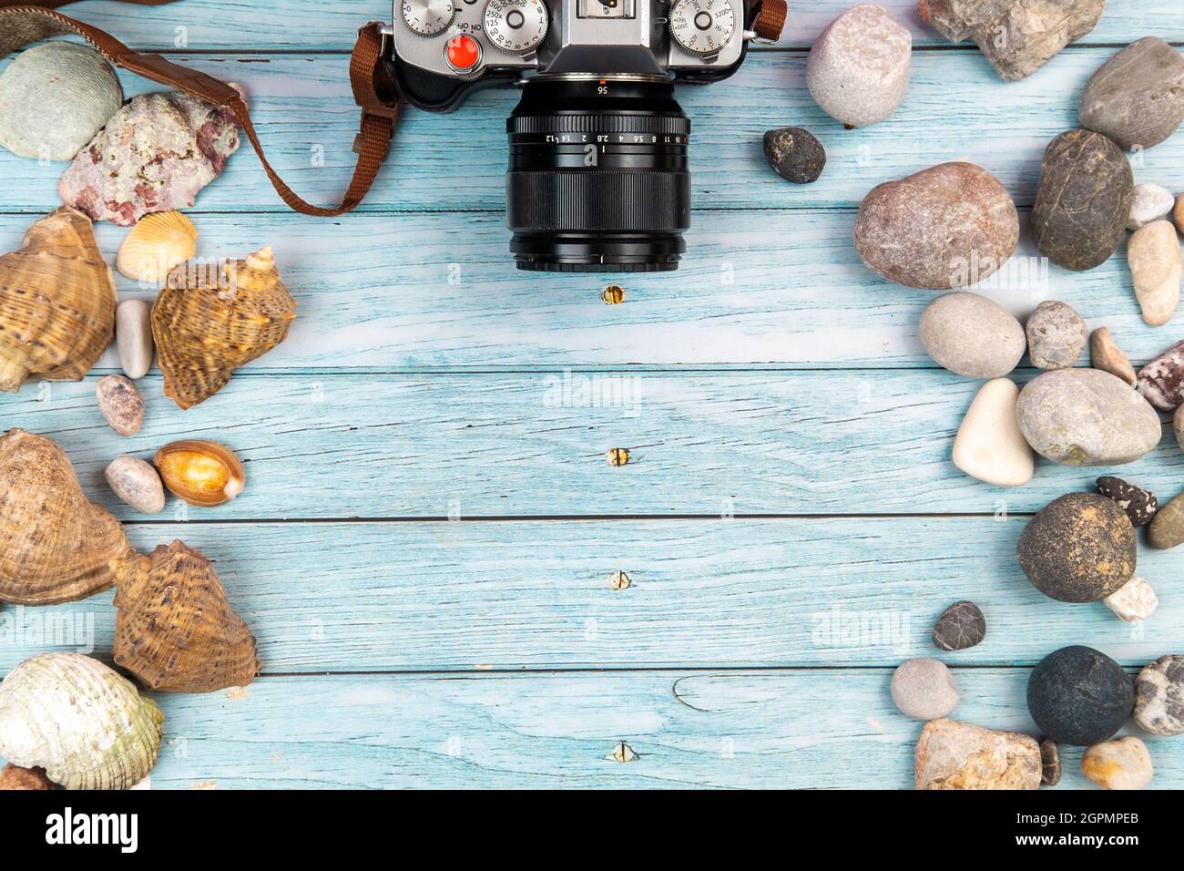 camera and seashells on a blue wooden background.Marine theme Stock ...