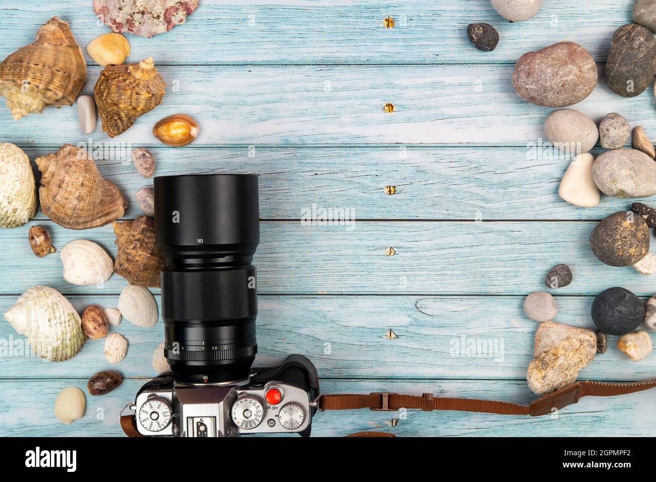 camera and seashells on a blue wooden background.Marine theme Stock ...
