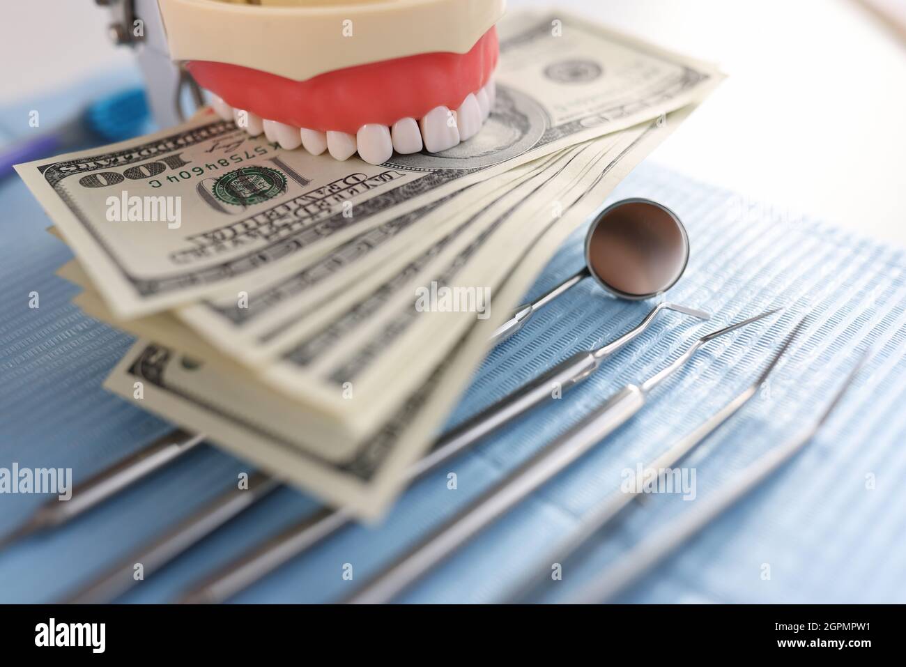 Dental artificial jaw instrument and one hundred dollar bills on ...