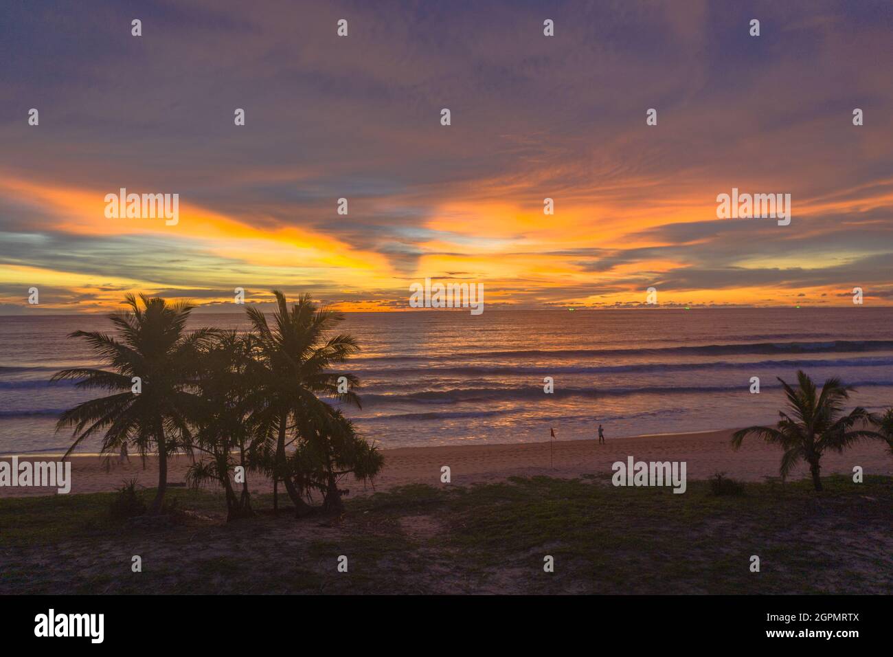 the colorful clouds are changing color in sky at sunset above the sea ...