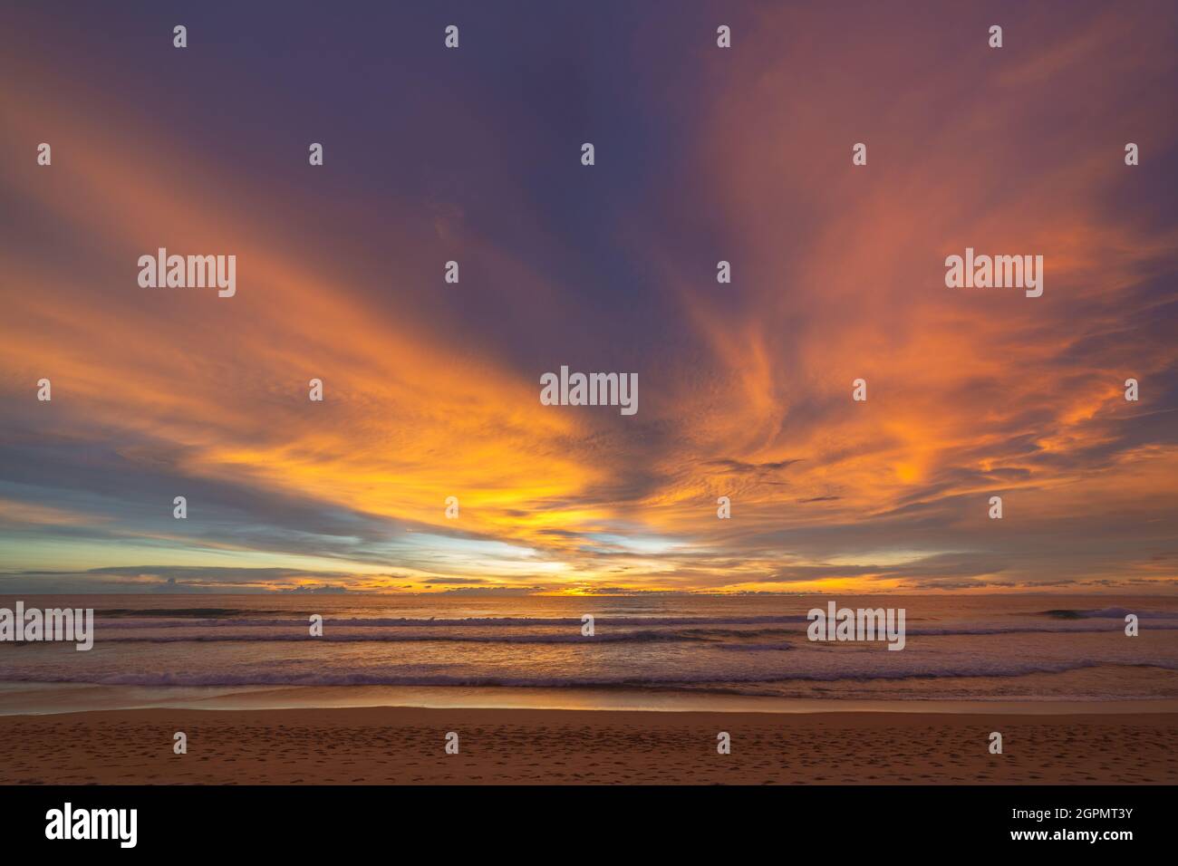 the colorful clouds are changing color in sky at sunset above the sea ...