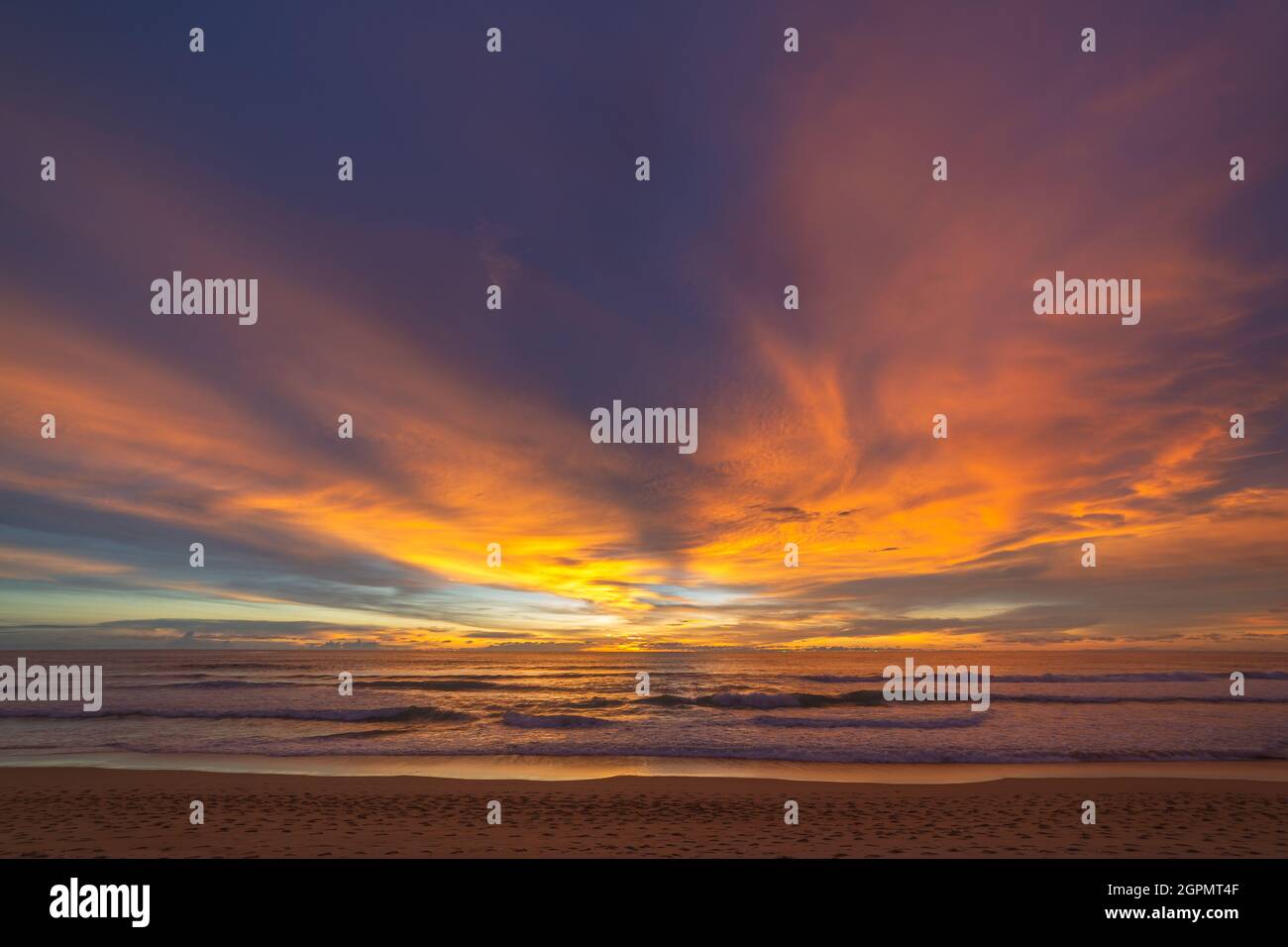 the colorful clouds are changing color in sky at sunset above the sea ...