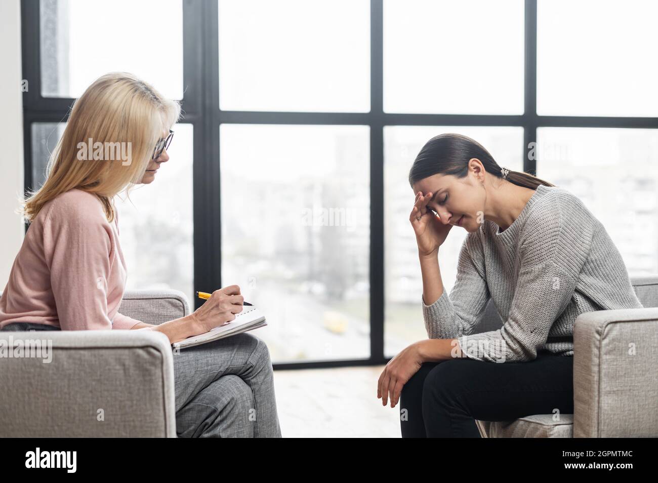 Frustrated young female patient speaking about issues and fears during ...