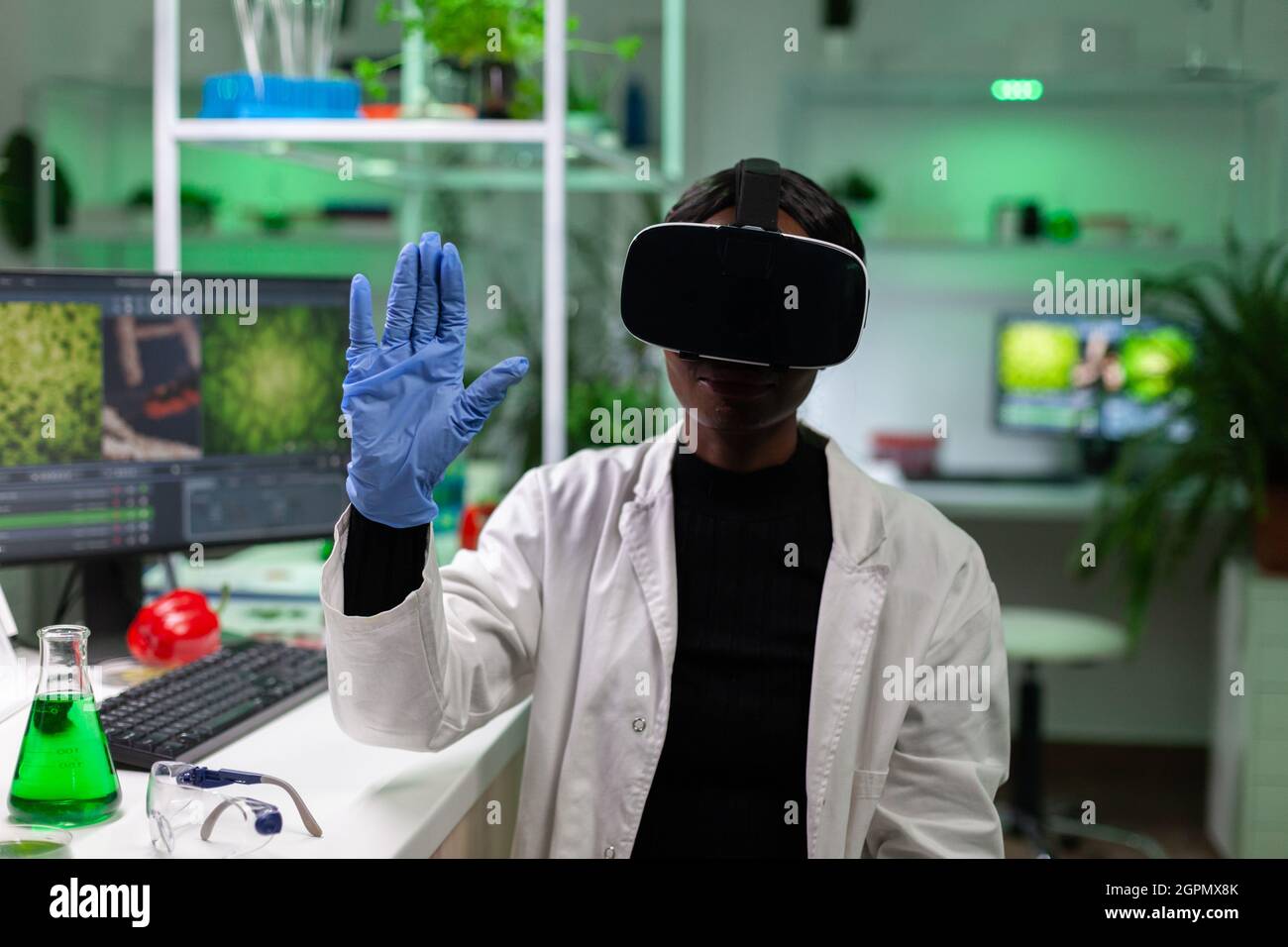African american biologist woman wearing virtual reality headset ...