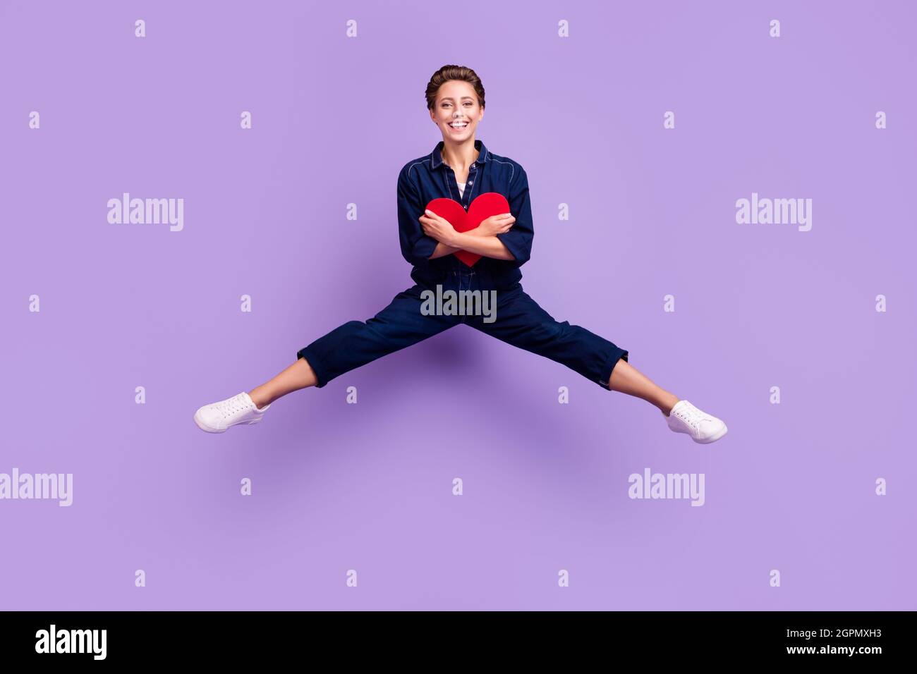 Full size photo of young lovely smiling girl jumping hug red paper ...
