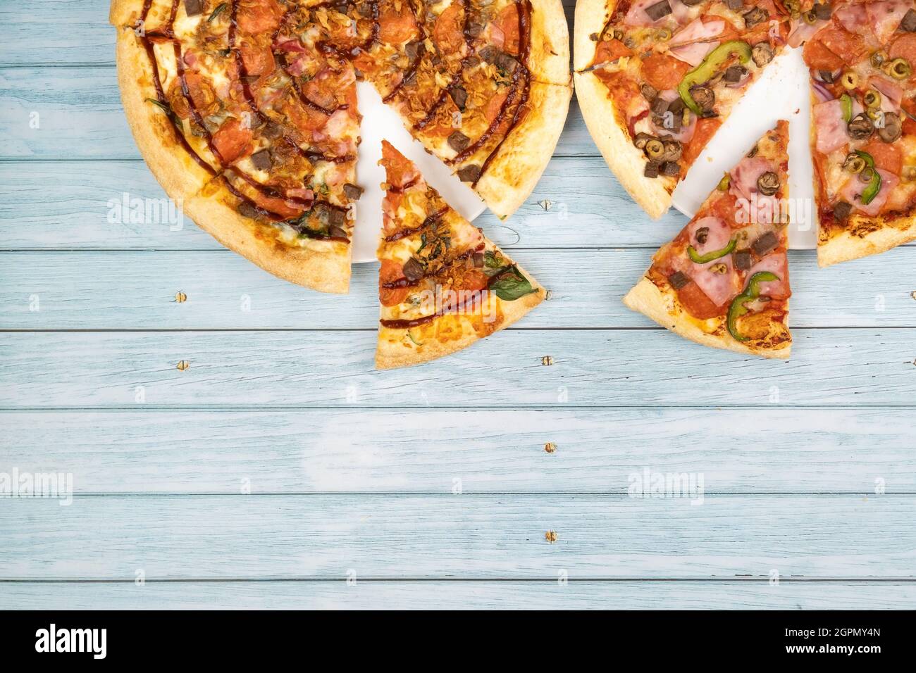 Two different delicious big pizzas on a blue wooden background Stock ...