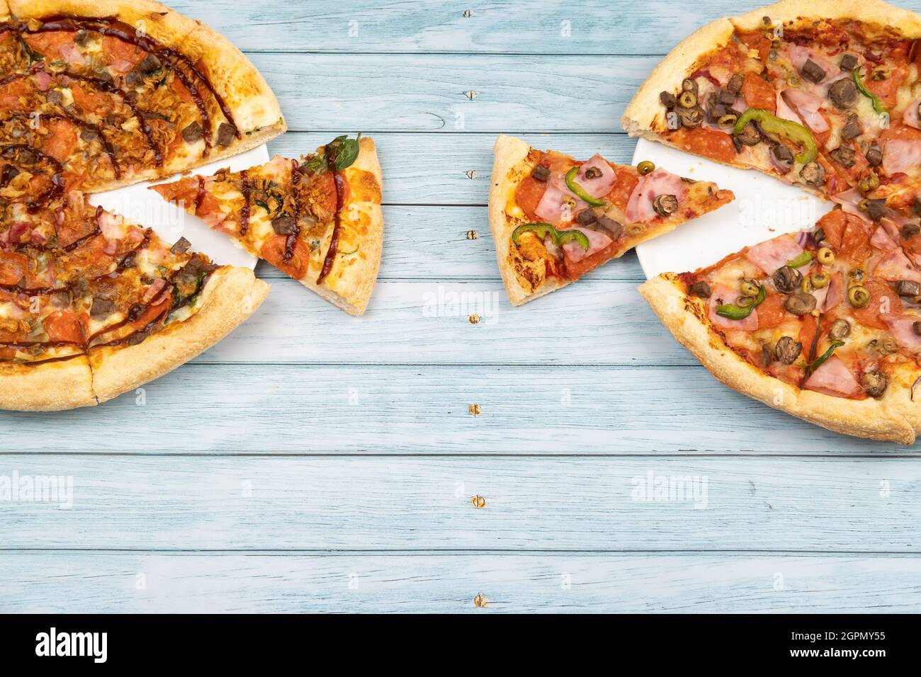 Two different delicious big pizzas on a blue wooden background Stock ...