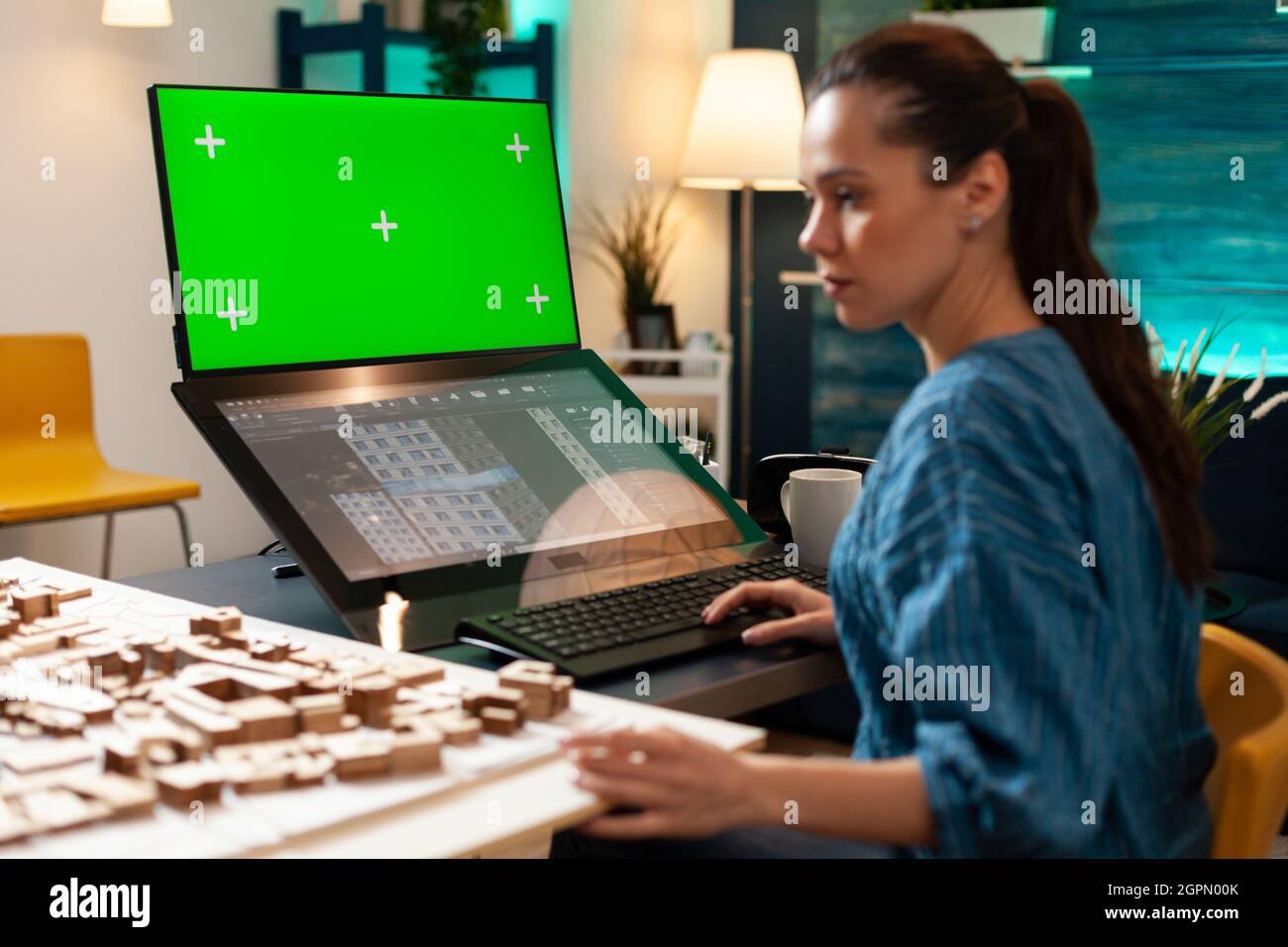 Architecture manager with design plan and green screen on computer ...