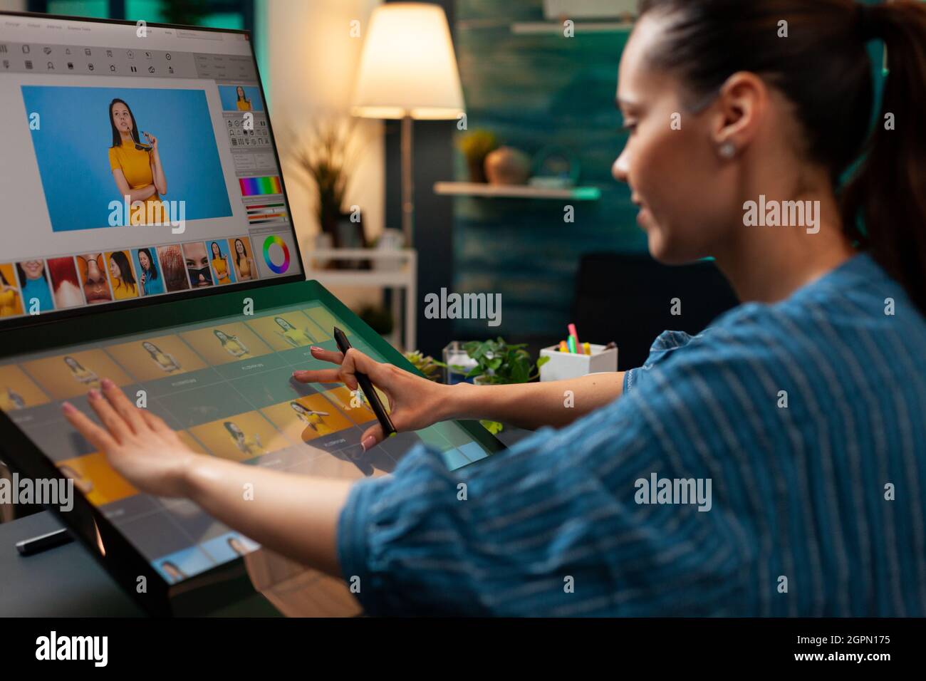 Photo editor artist doing touchpad work on retouching image using ...