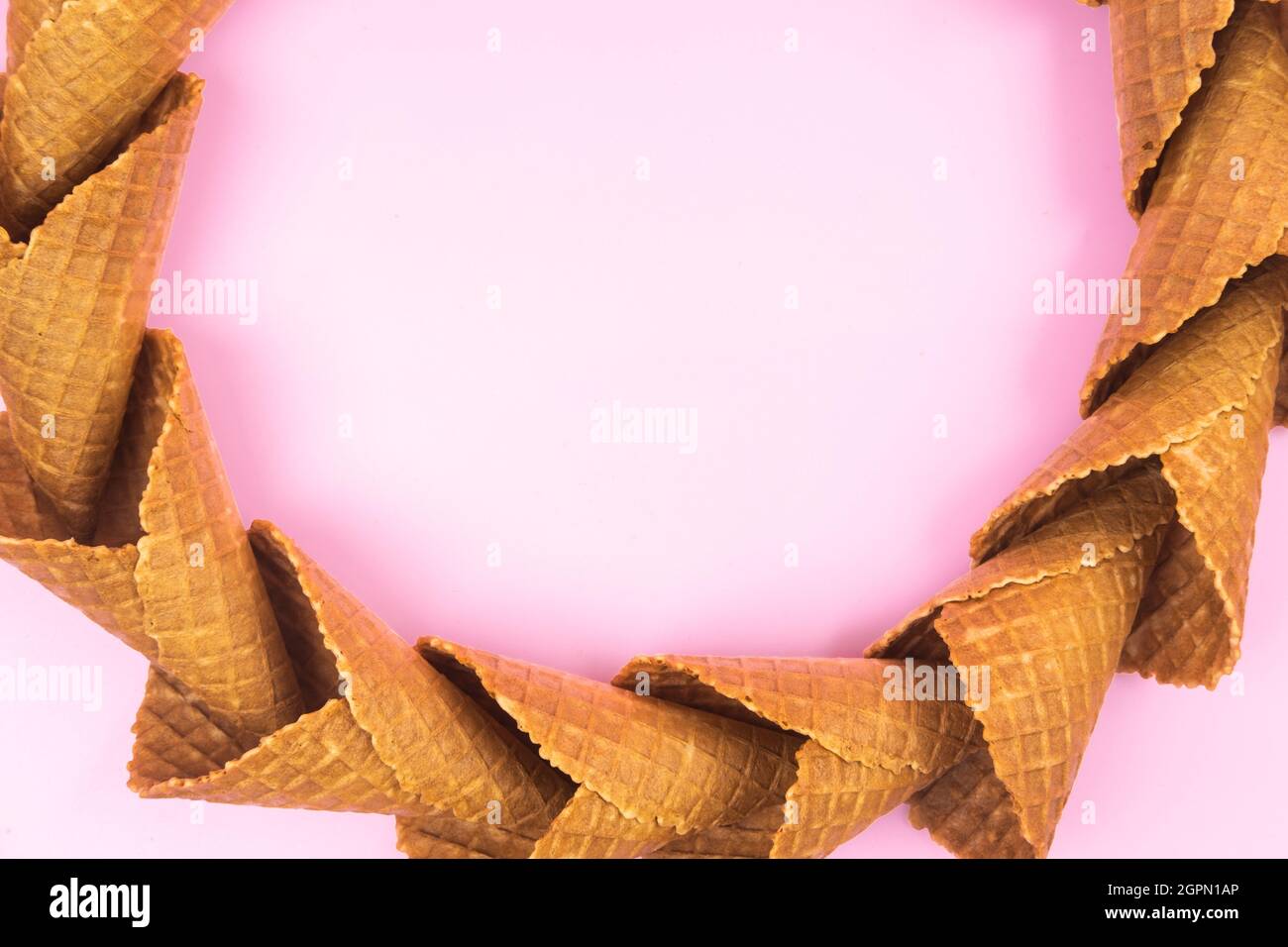 smooth circle of waffle cones for ice cream on a pink background Stock ...