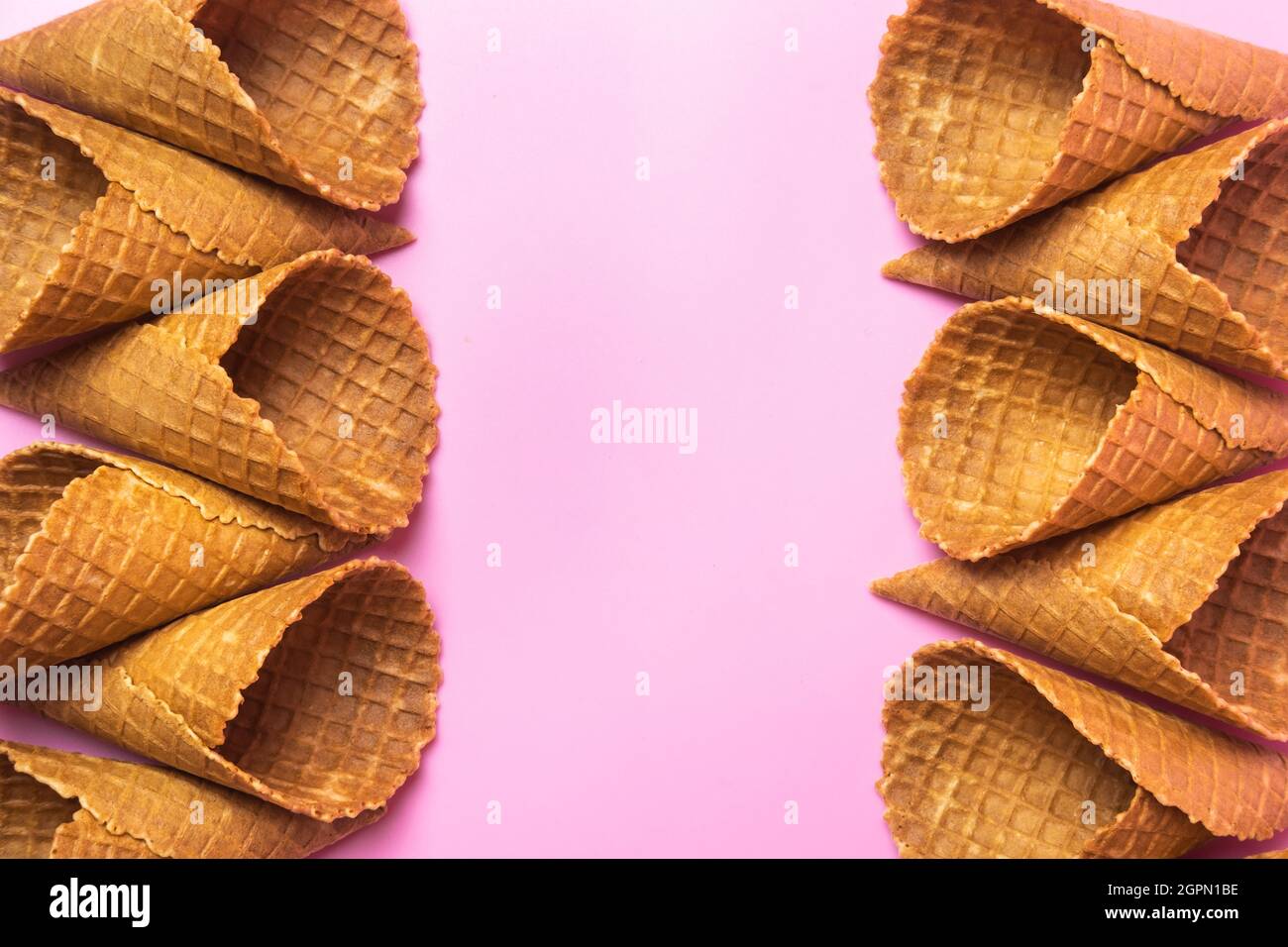 Empty waffle cones for ice cream on a pink background Stock Photo - Alamy