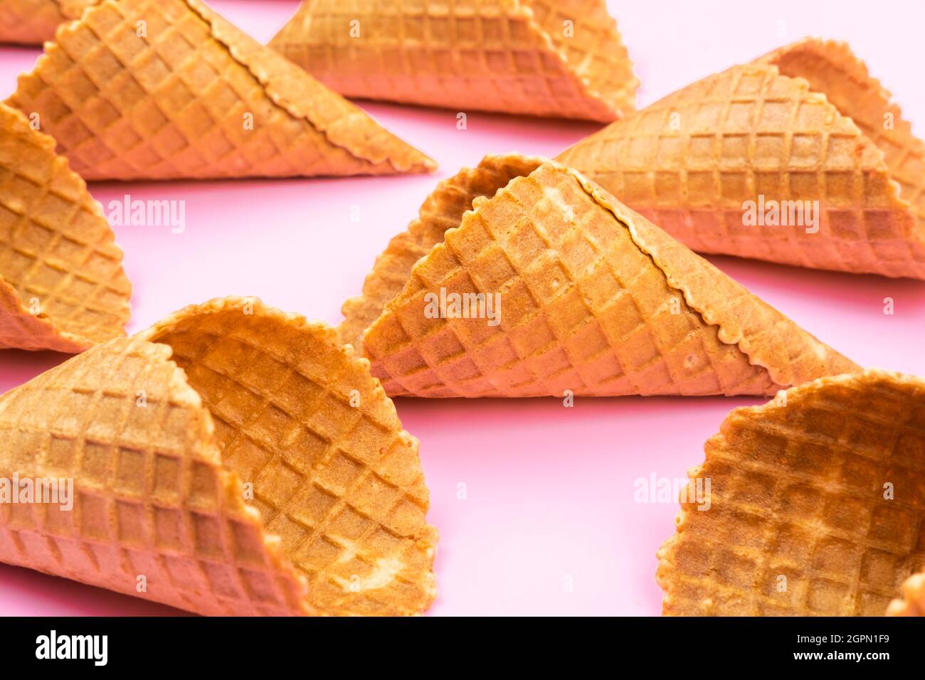 Waffle empty ice cream cones on a colored pink background Stock Photo ...