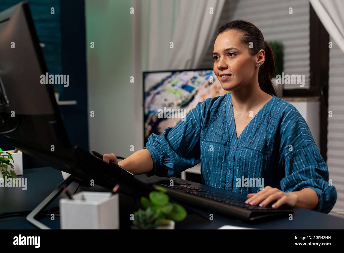 Creative editing artist using retoucher software on photo sitting at ...