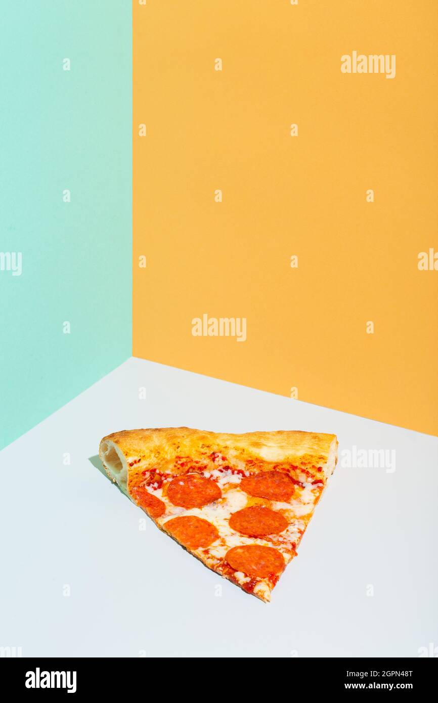Slice of Pepperoni Pizza orange grey turquoise paper background modern ...