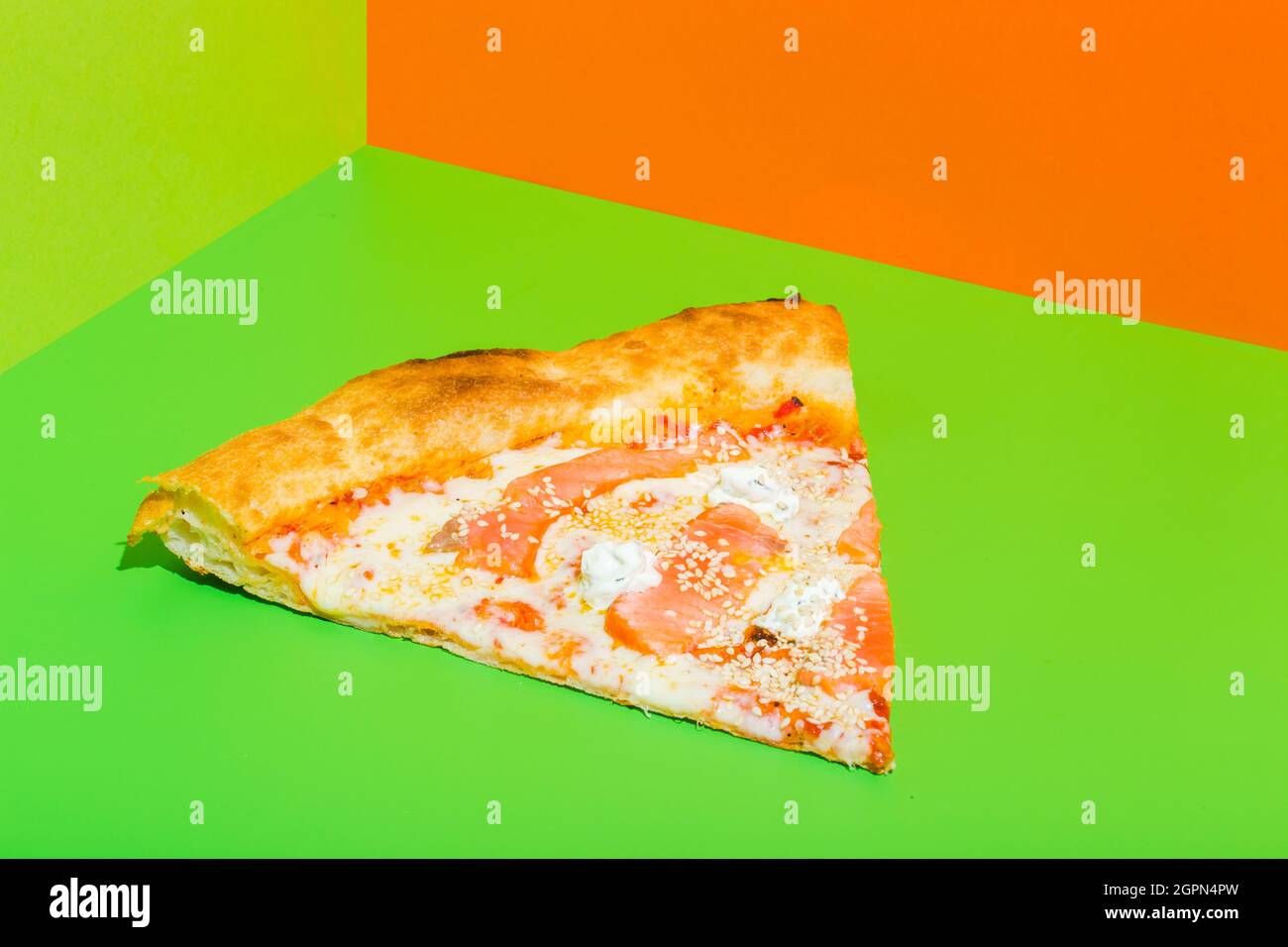 Pizza with Mozzarella cheese, salmon fish. Italian pizza on green paper ...