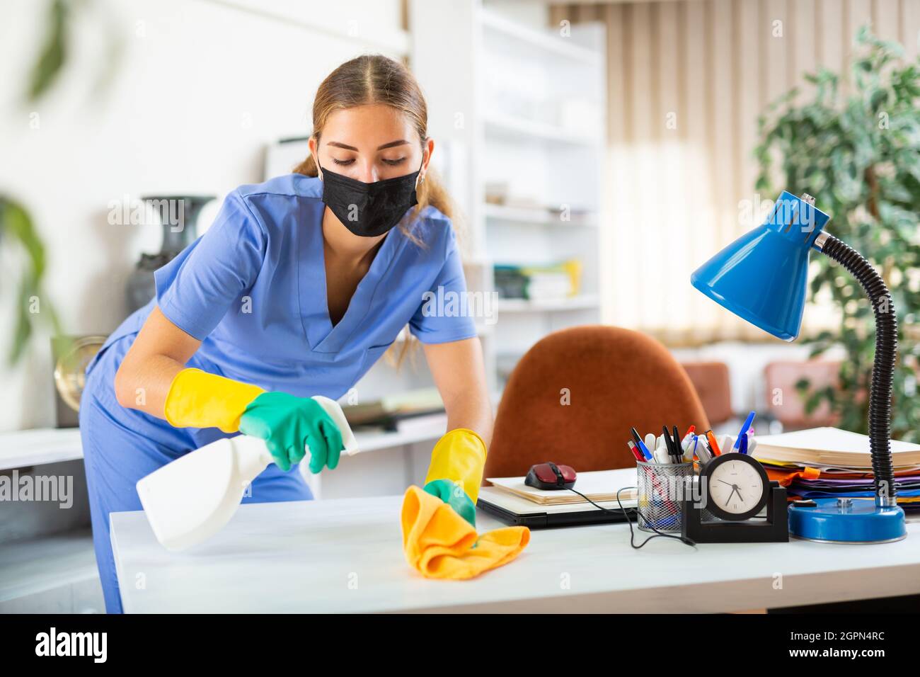 Professional female worker of office cleaning service wearing ...