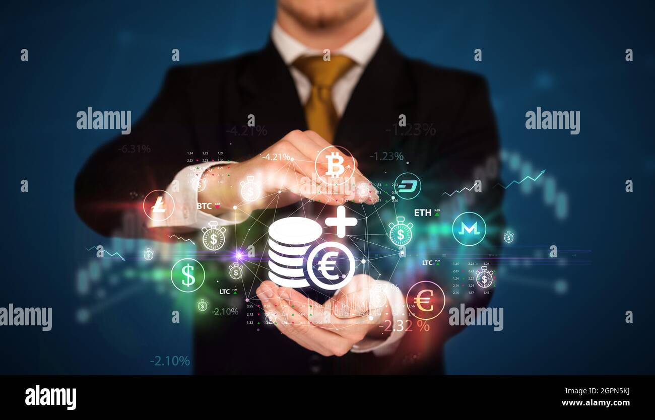 Businessman holding currency symbols concept Stock Photo - Alamy