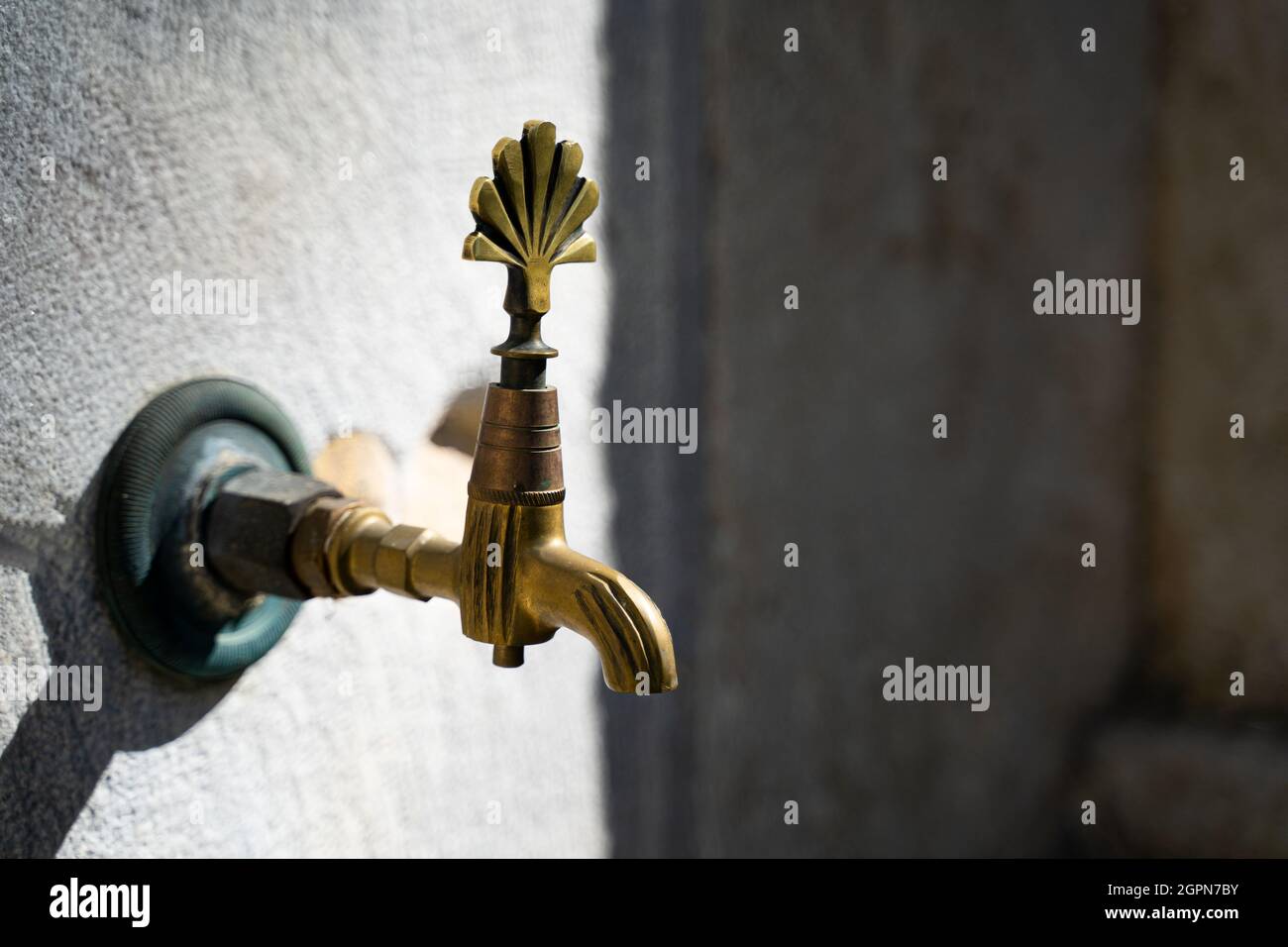 closeup of vintage bronze water faucet with decorated tap next to a ...