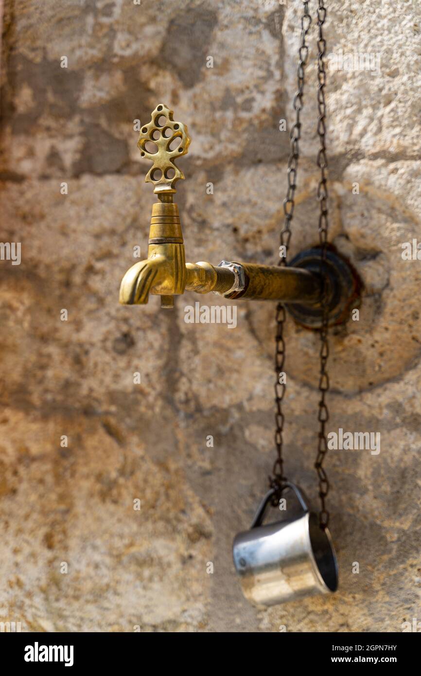 closeup of vintage bronze water faucet with decorated tap and metal ...