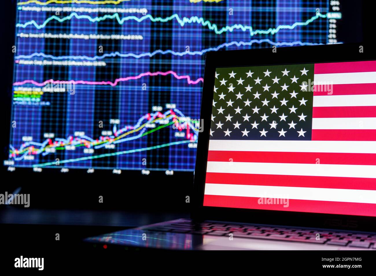 USA flag on screen and stocks and finance graphs in background Stock ...